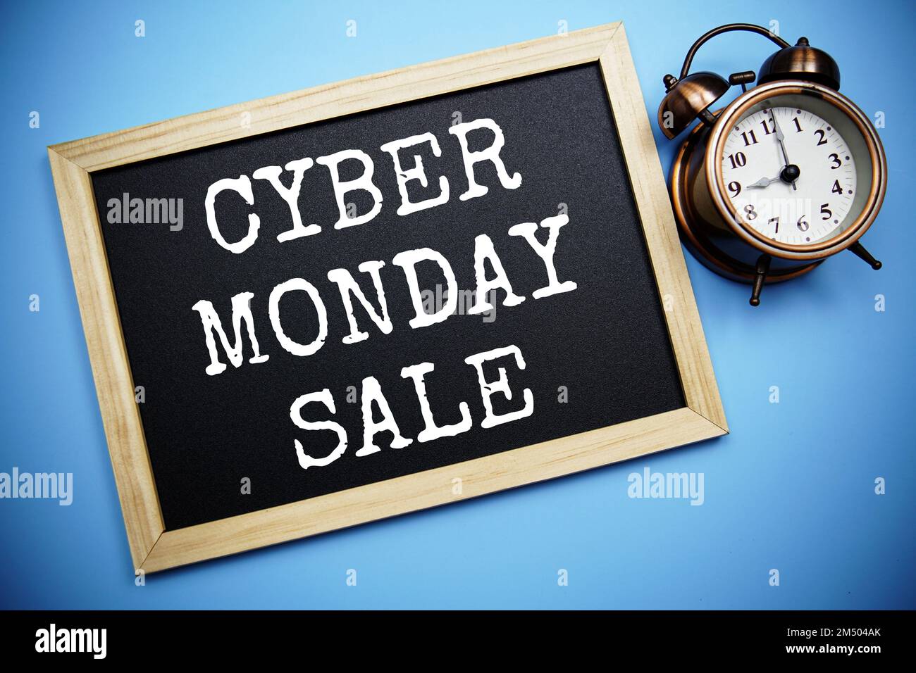 Cyber Monday Sale text message on Blackboard and alarm clock on blue ...