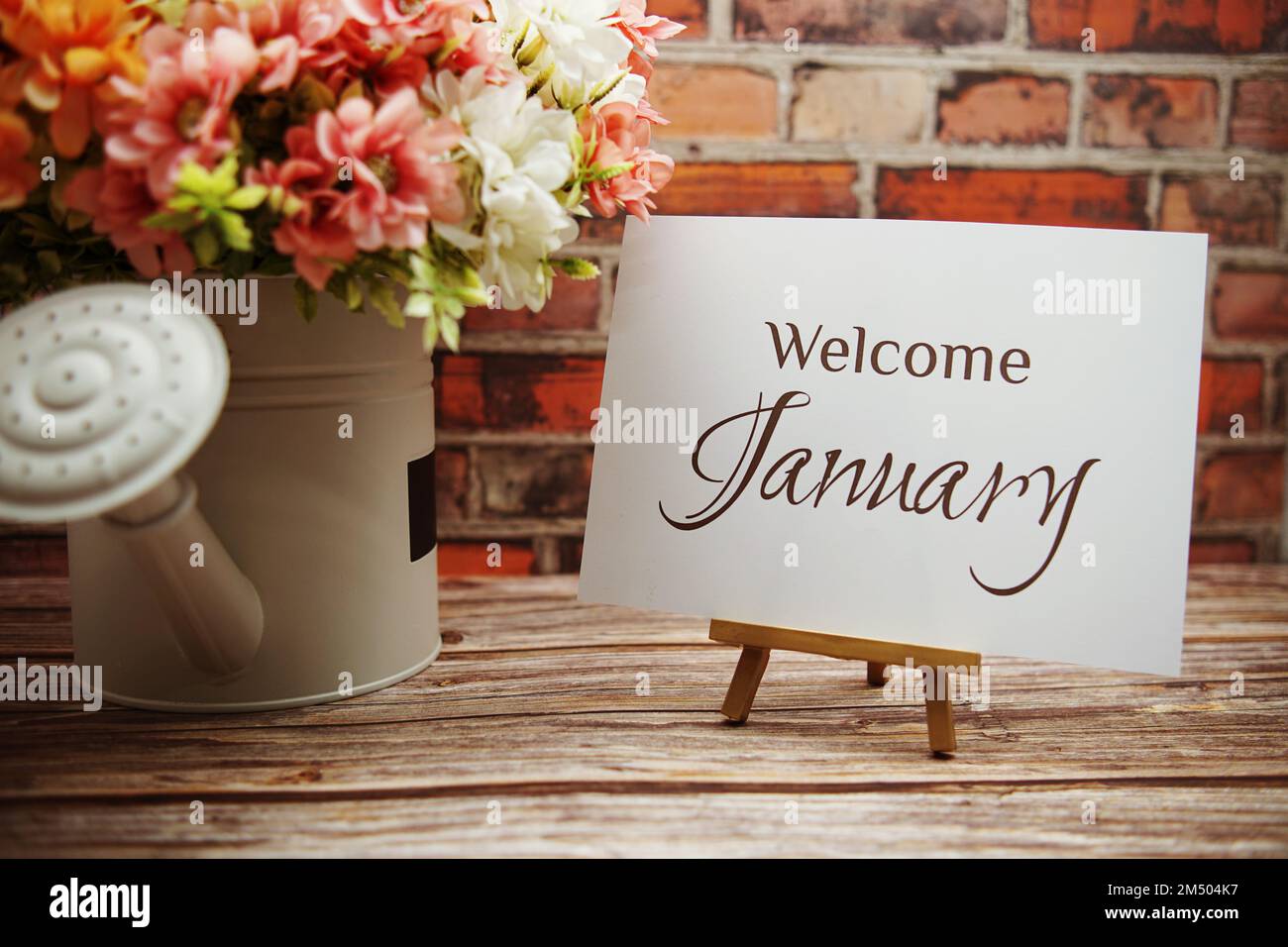 Welcome January text with flower bouquet decoration on wooden and old ...