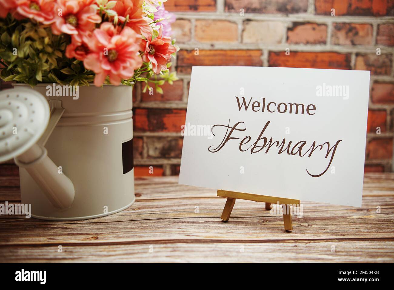 Welcome February text with flower bouquet decoration on wooden and old ...