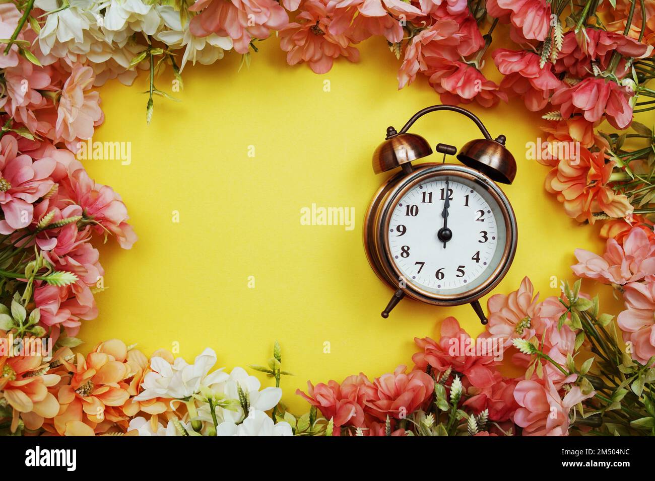 Alarm clock with flower frame decoration on yellow background Stock ...