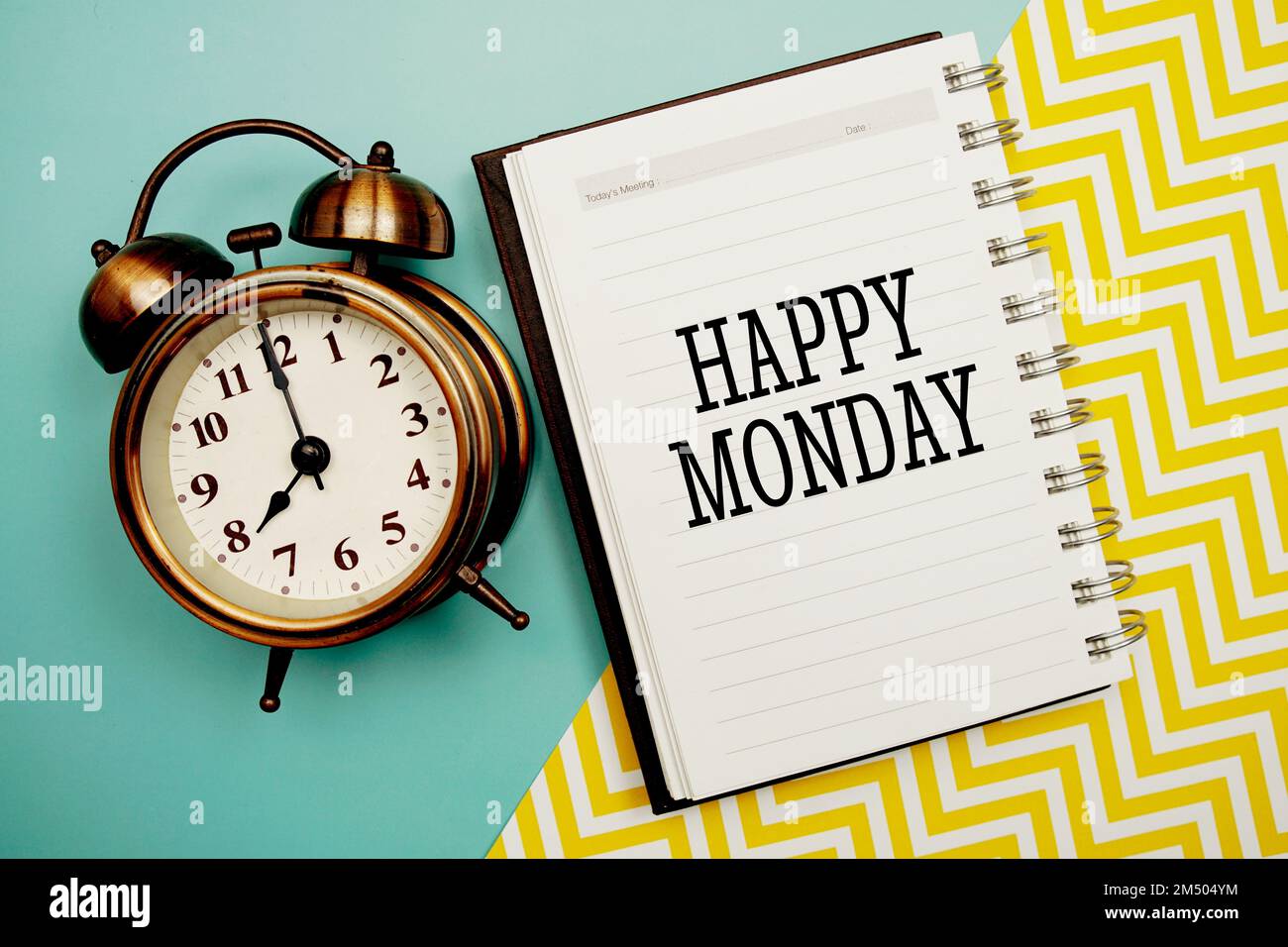 Happy Monday text and alarm clock on blue background Stock Photo - Alamy
