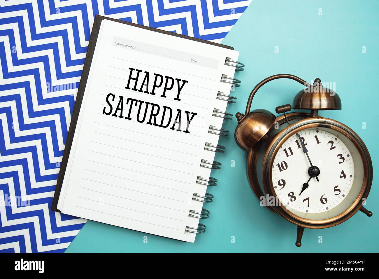 Happy Saturday text and alarm clock on blue background Stock Photo - Alamy