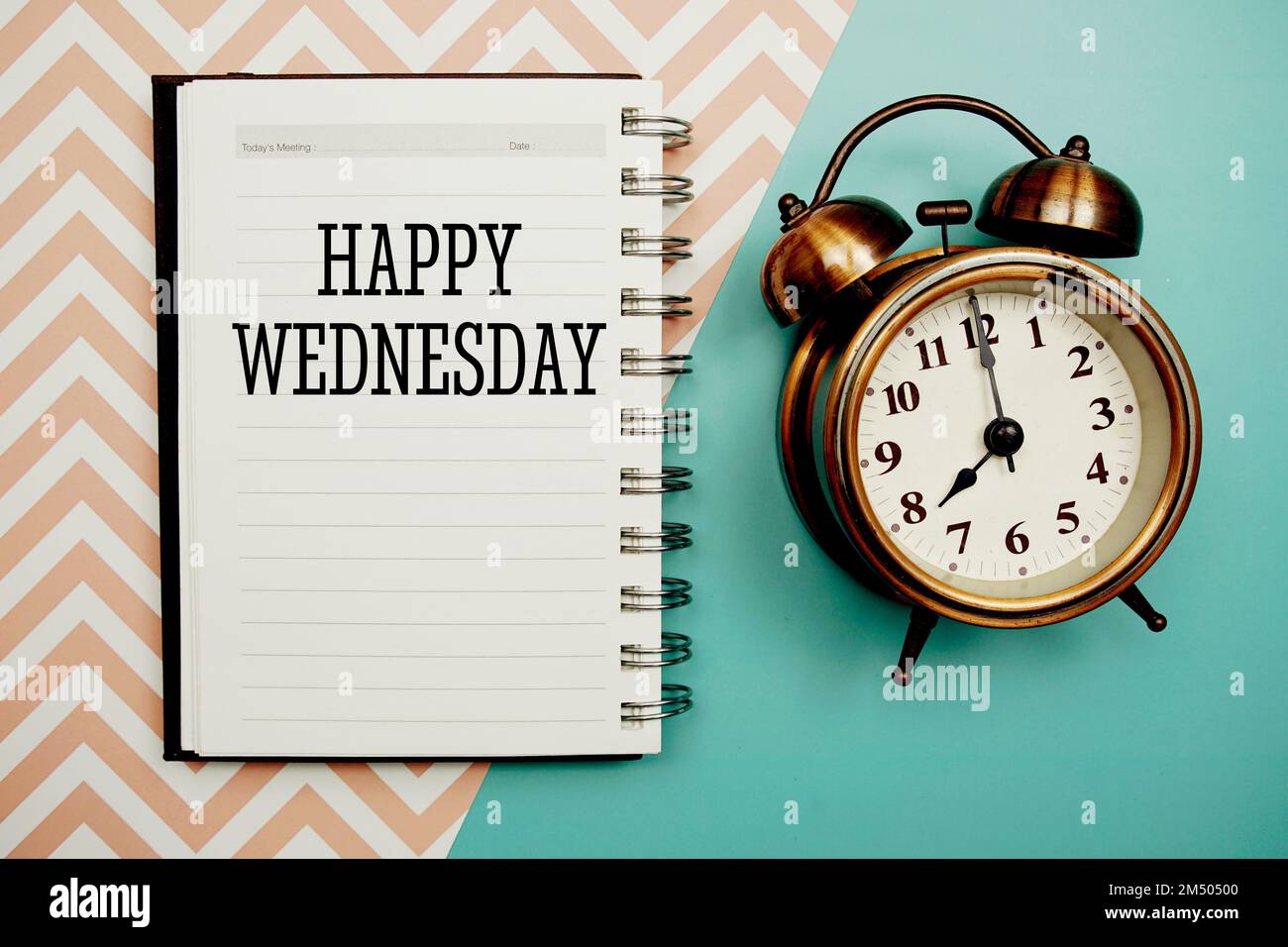 Happy Wednesday text and alarm clock on blue background Stock Photo - Alamy
