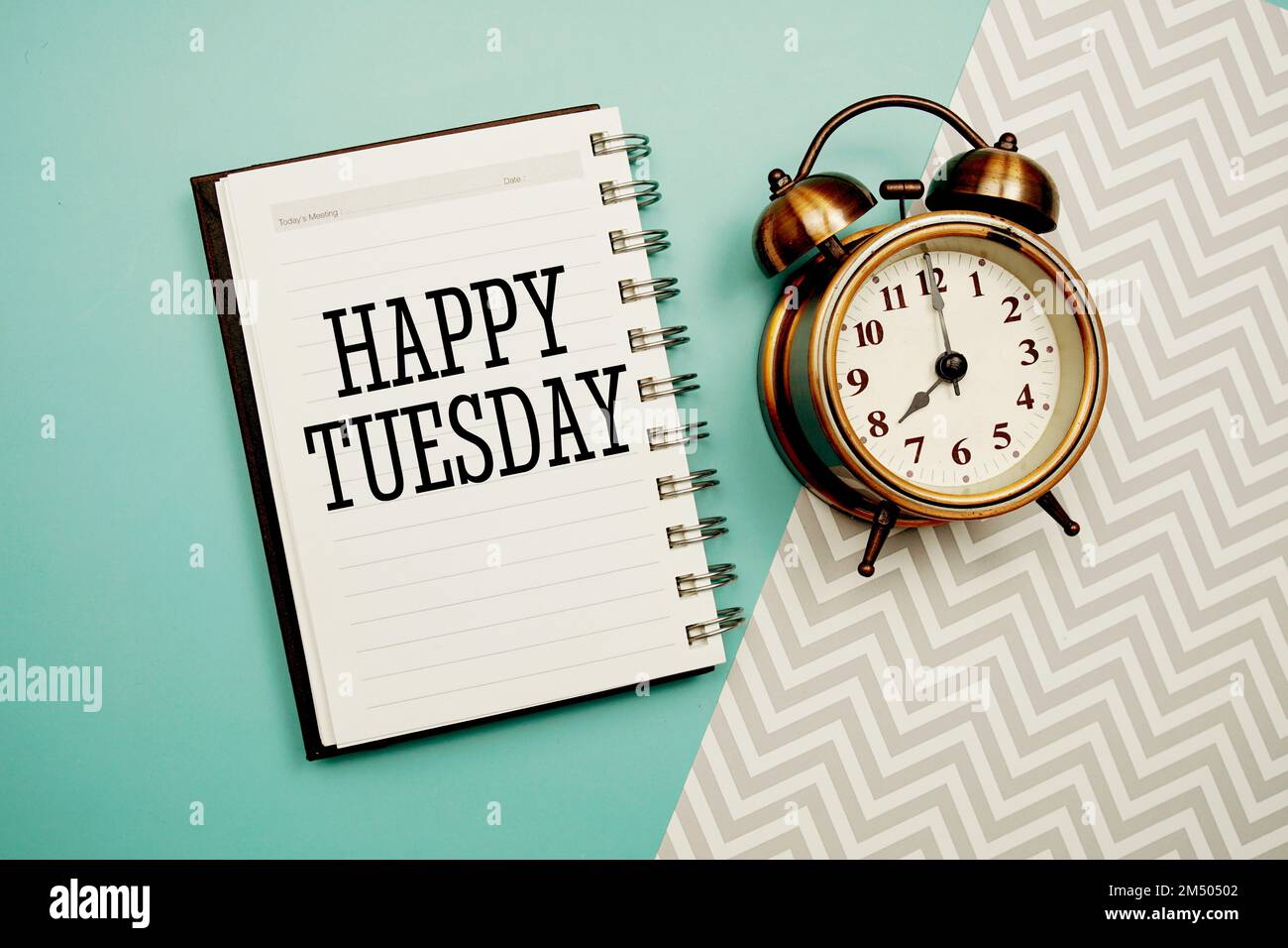 Happy Tuesday text and alarm clock on blue background Stock Photo - Alamy