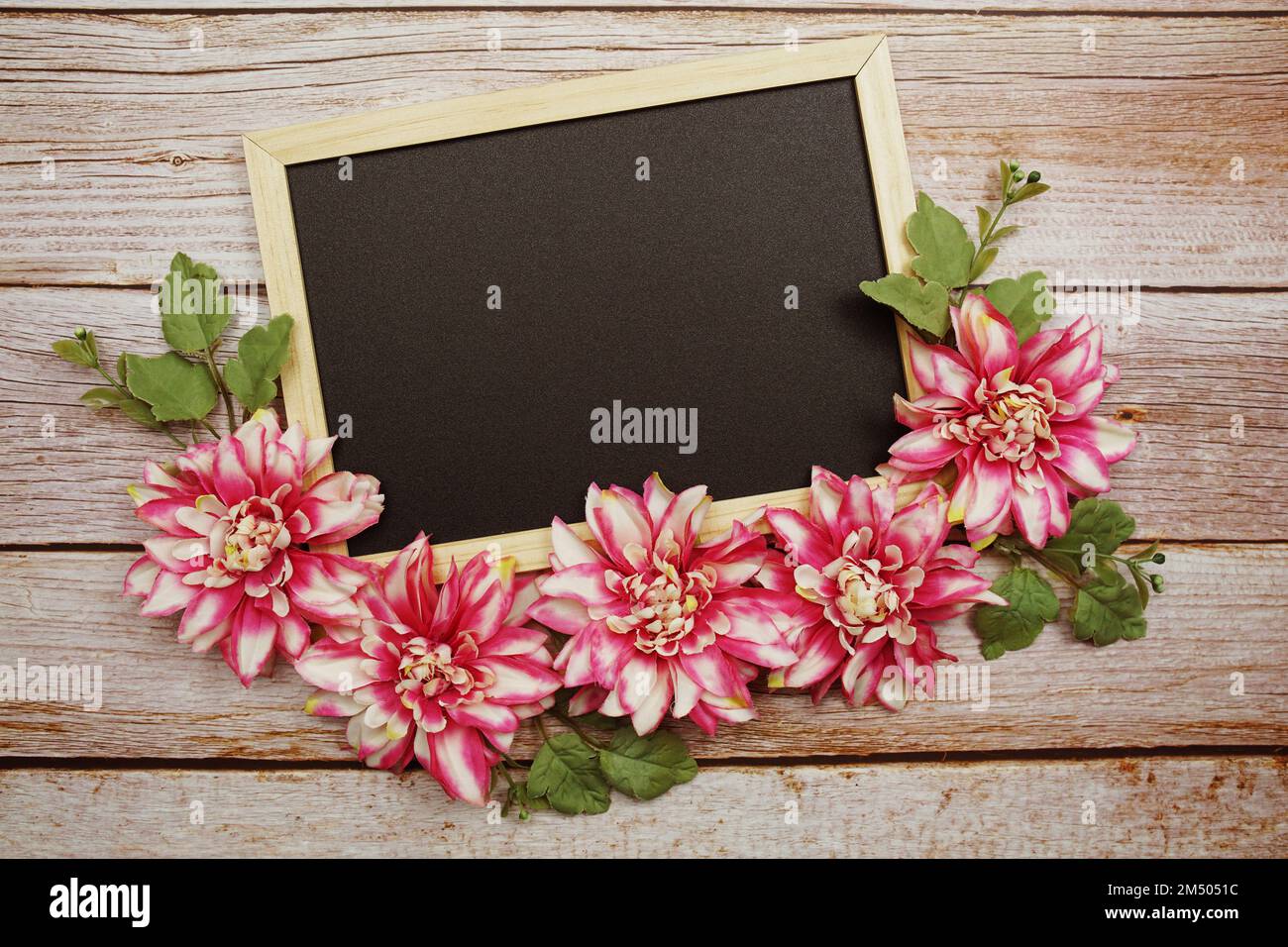 Blackboard with flower decorate on wooden background Stock Photo - Alamy