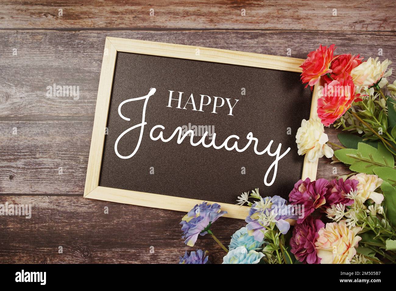 Hello January typography text and flower decoration on blackboard ...