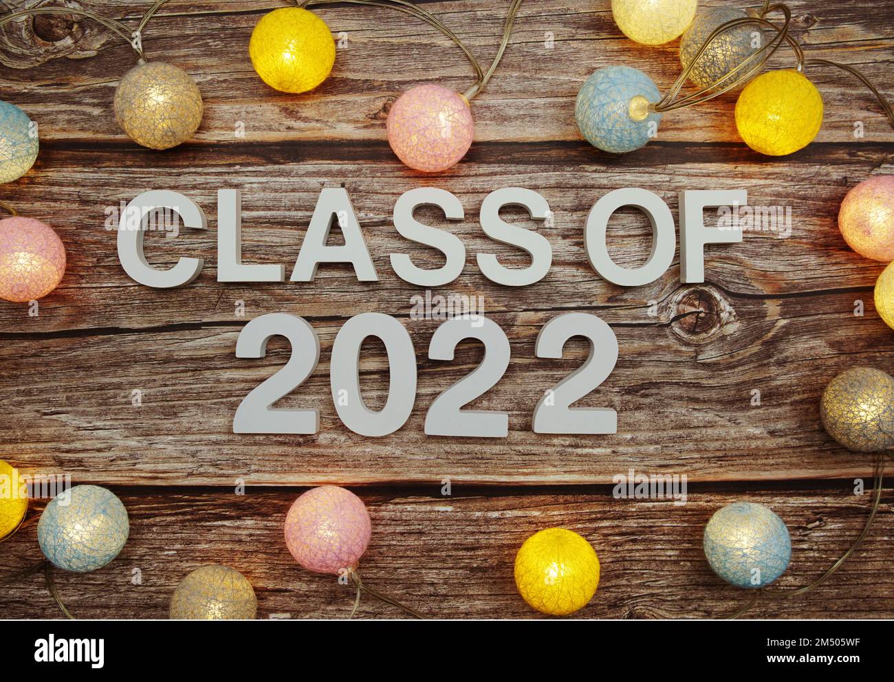 Class of 2022 on paper card with LED cotton balls top view on wooden ...