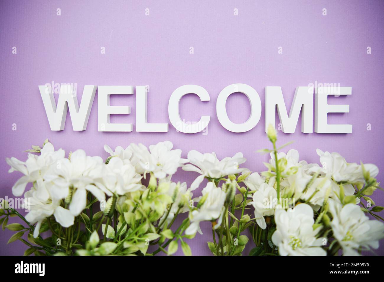 Welcome alphabet letters decorate with Flowers on purple background Stock Photo - Alamy
