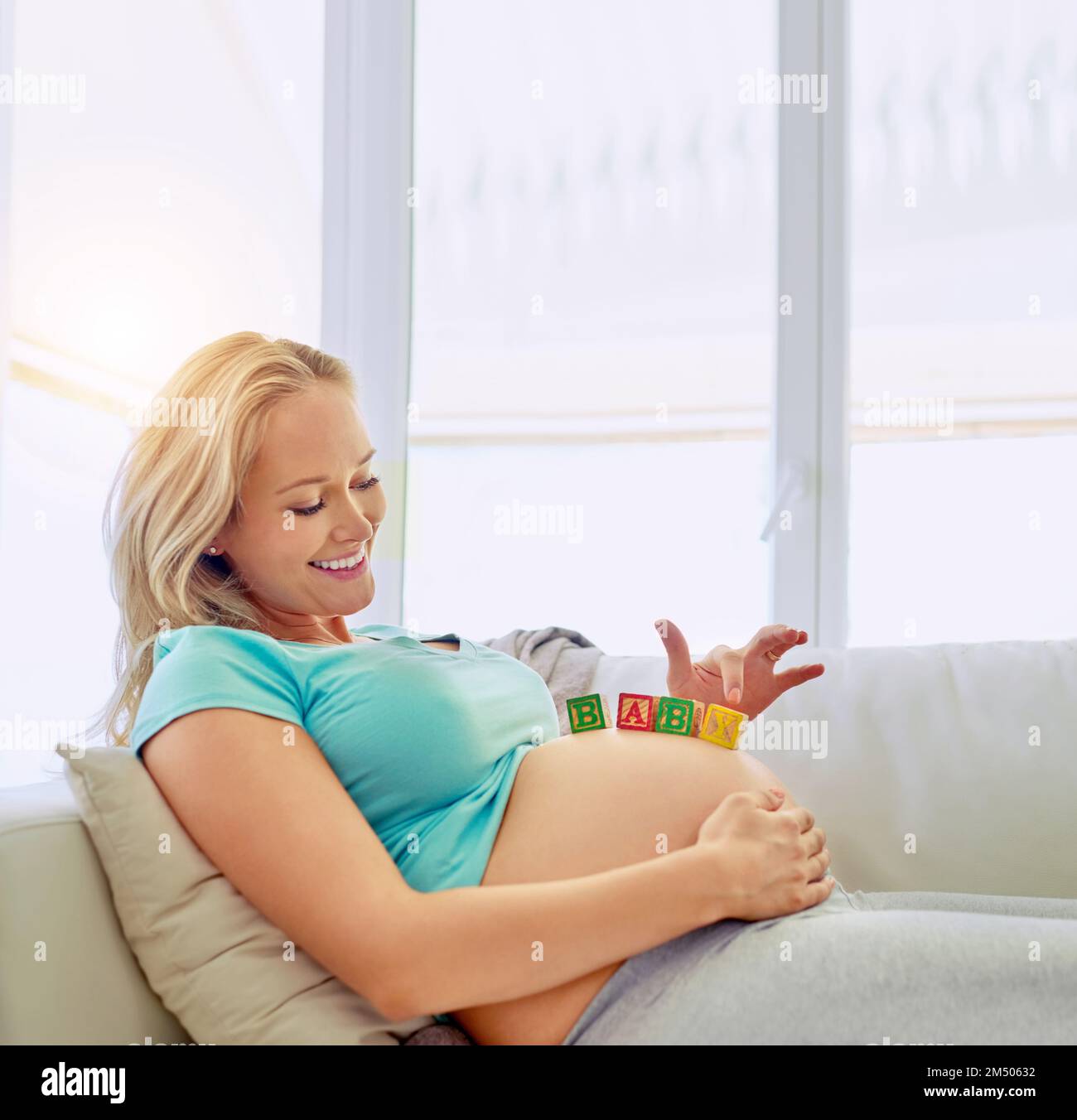 Guess wholl be arriving soon. a pregnant woman lying down with wooden ...