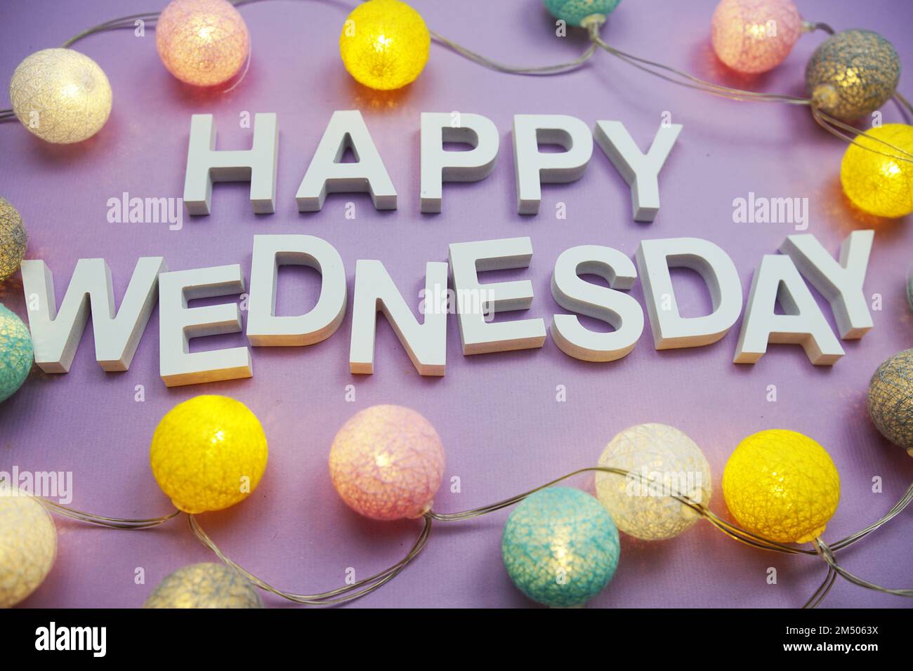 Happy Wednesday alphabet letters with LED cotton balls on purple ...