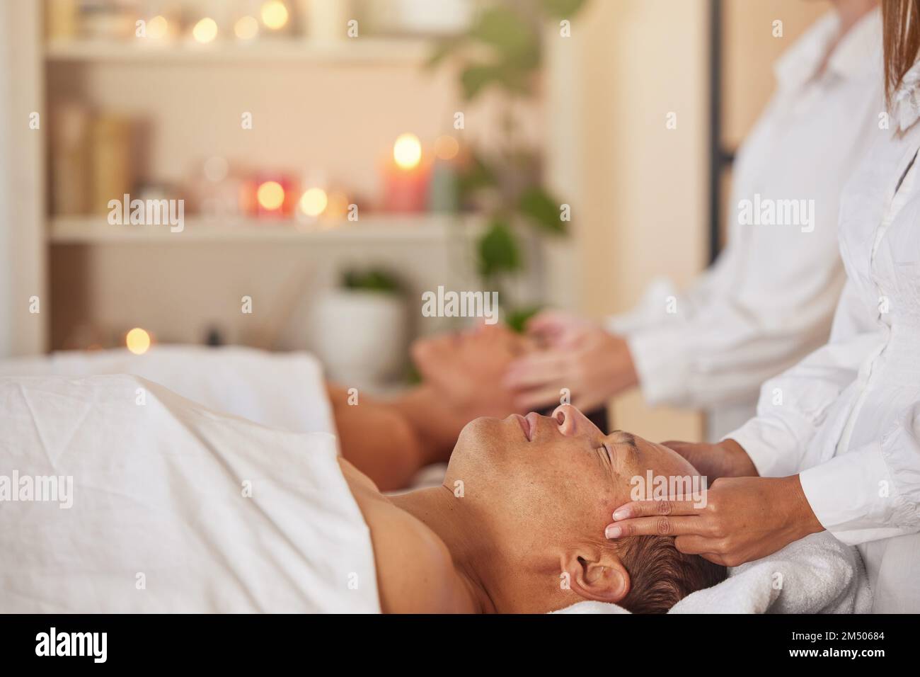 Massage, reiki and couple at spa with therapist hand, chakra balance ...
