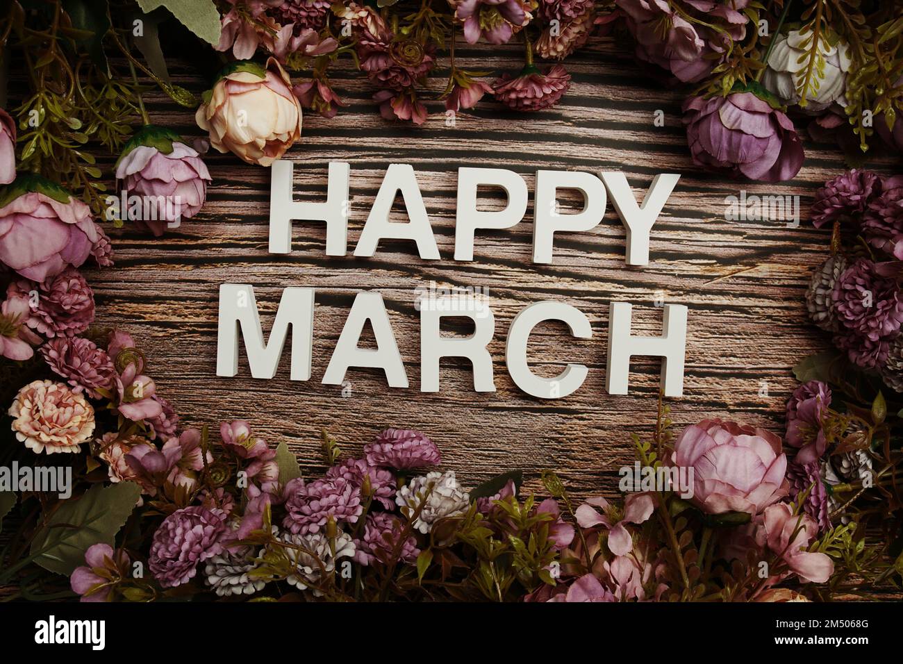 Happy March alphabet letters with flowers frame on wooden background ...