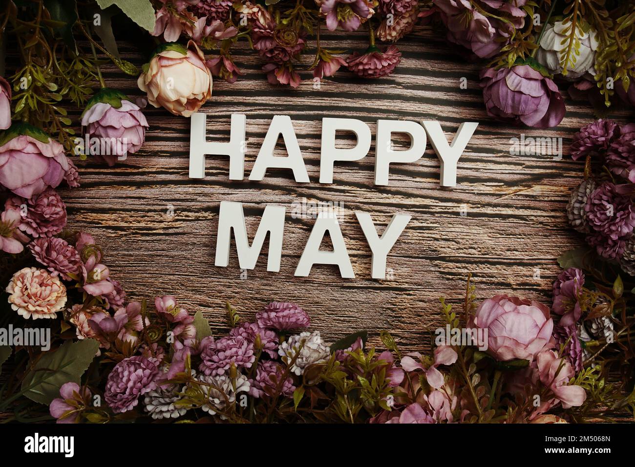 Happy May alphabet letters with flowers frame on wooden background ...