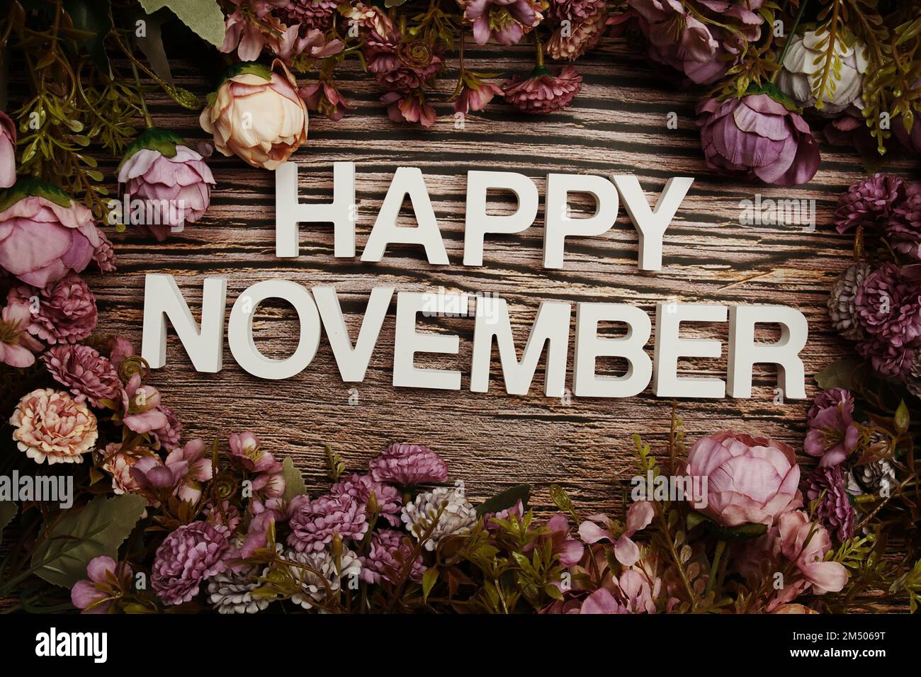 Happy November alphabet letters with flowers frame on wooden background ...