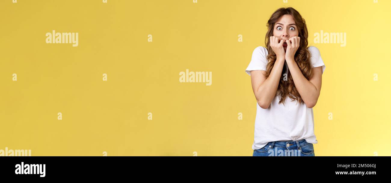 Shocked speechless scared stunned curly-haired caucasian woman gasping ...