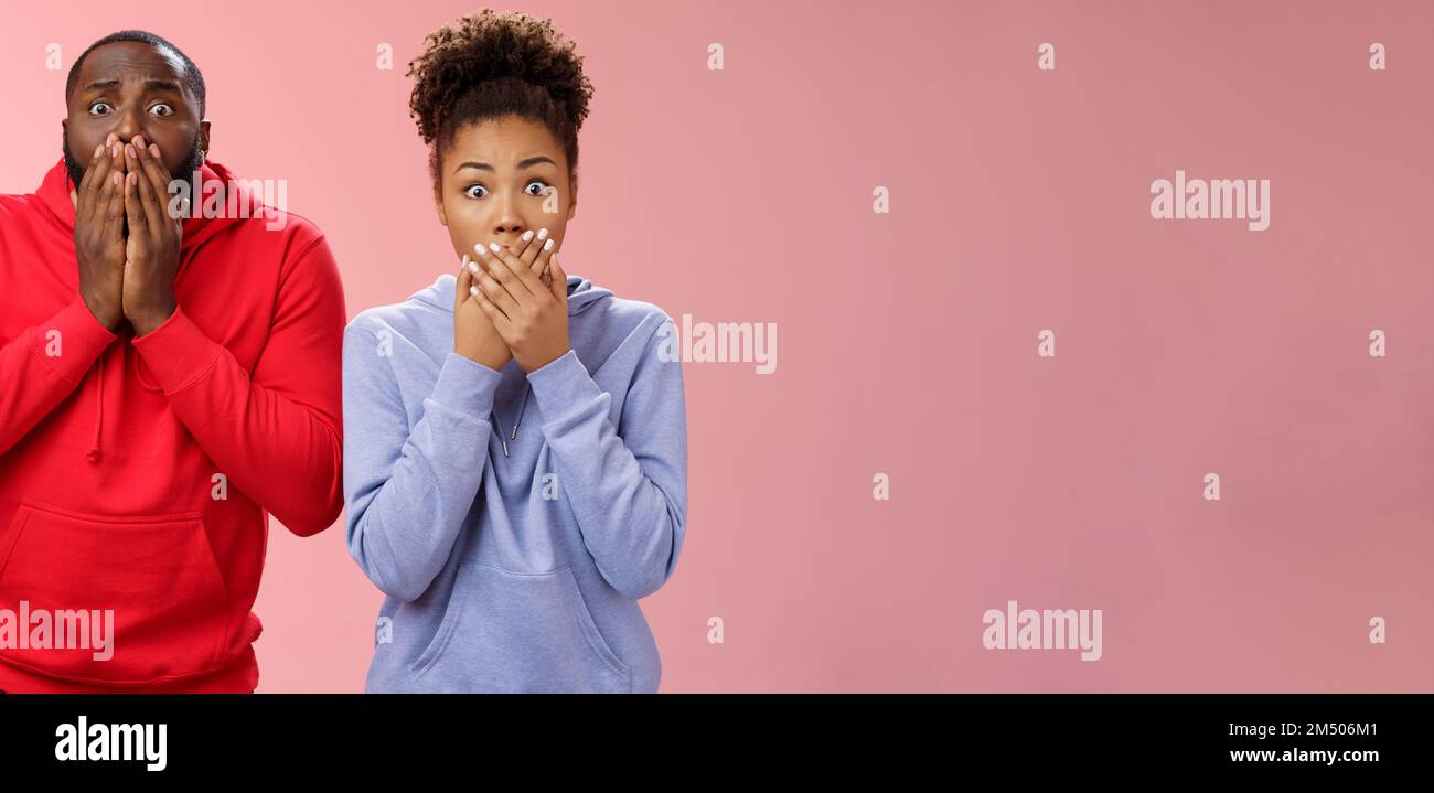 Two shocked african-american man woman widen eyes concerned terribly ...