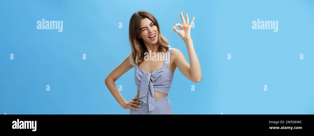 Cute charismatic woman with gap teeth showing okay gesture tilting head ...