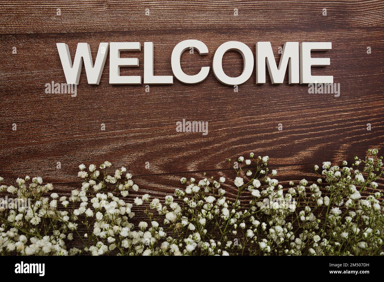 Welcome alphabet letters with flowers on wooden background Stock Photo ...