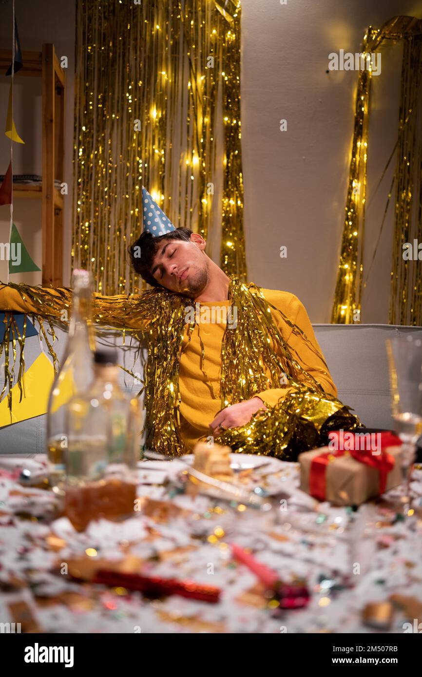Tired drunk male student after birthday party at home. Copy space Stock ...