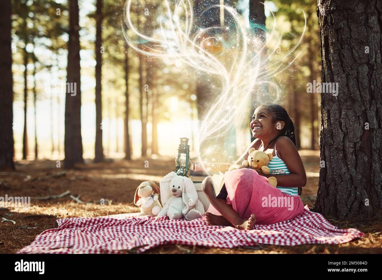 Reading lights up magical worlds for kids. a little girl reading a book ...