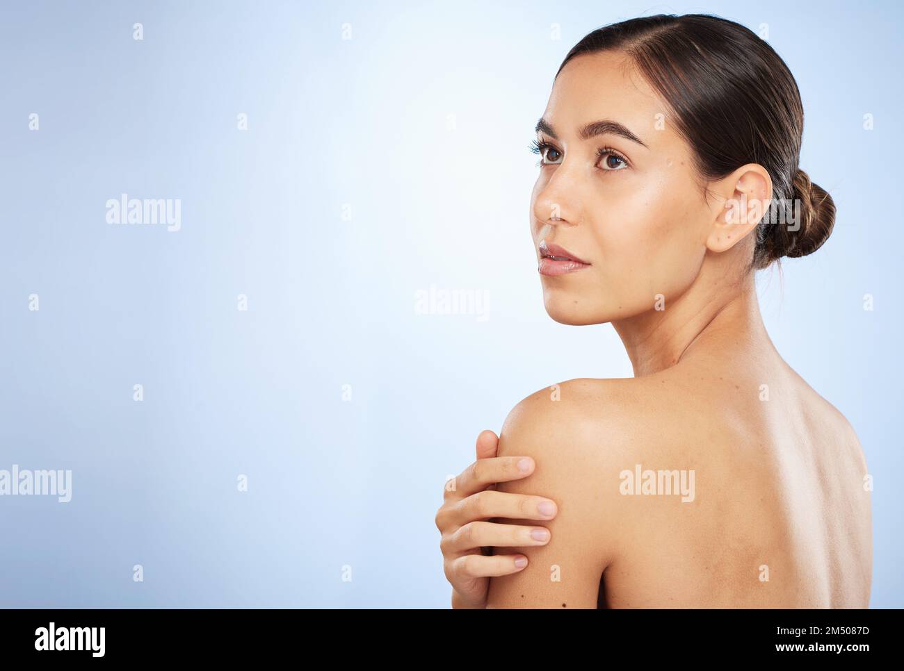 Face, beauty skincare and back of woman in studio isolated on a blue ...