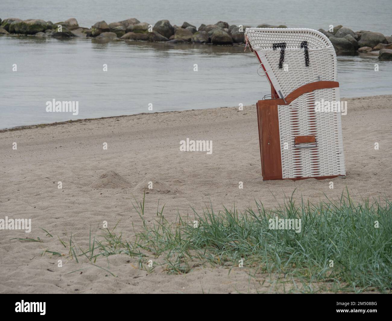 A beautiful shot of hooded beach chairs at the coast of Baltic sea in ...