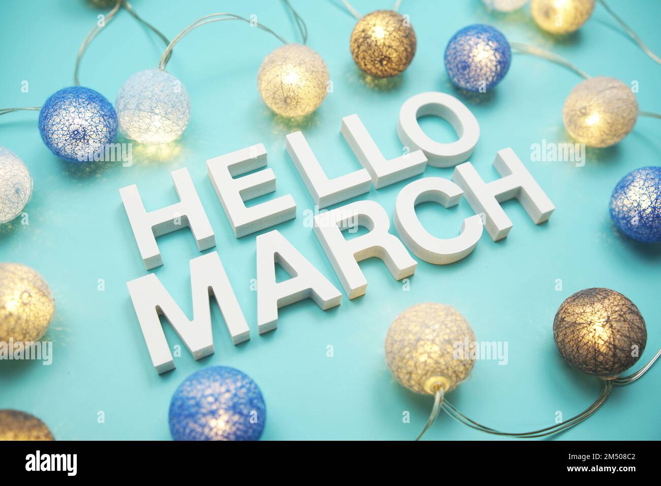 Hello March alphabet letter decorate with LED cotton balls on blue ...