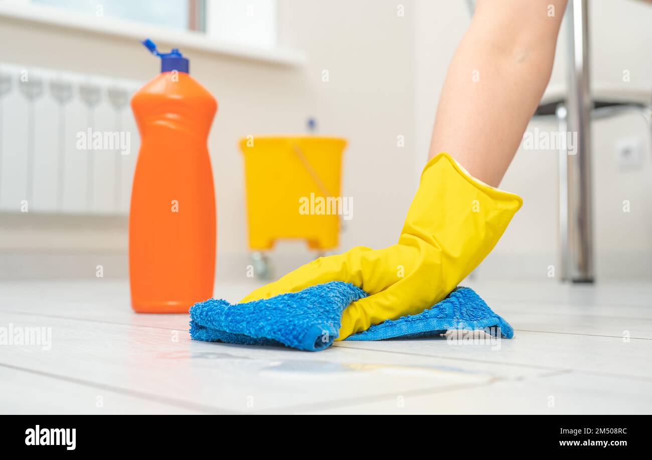 cleaning service. cleaning and care product for laminate and flooring. large orange bottle of ...