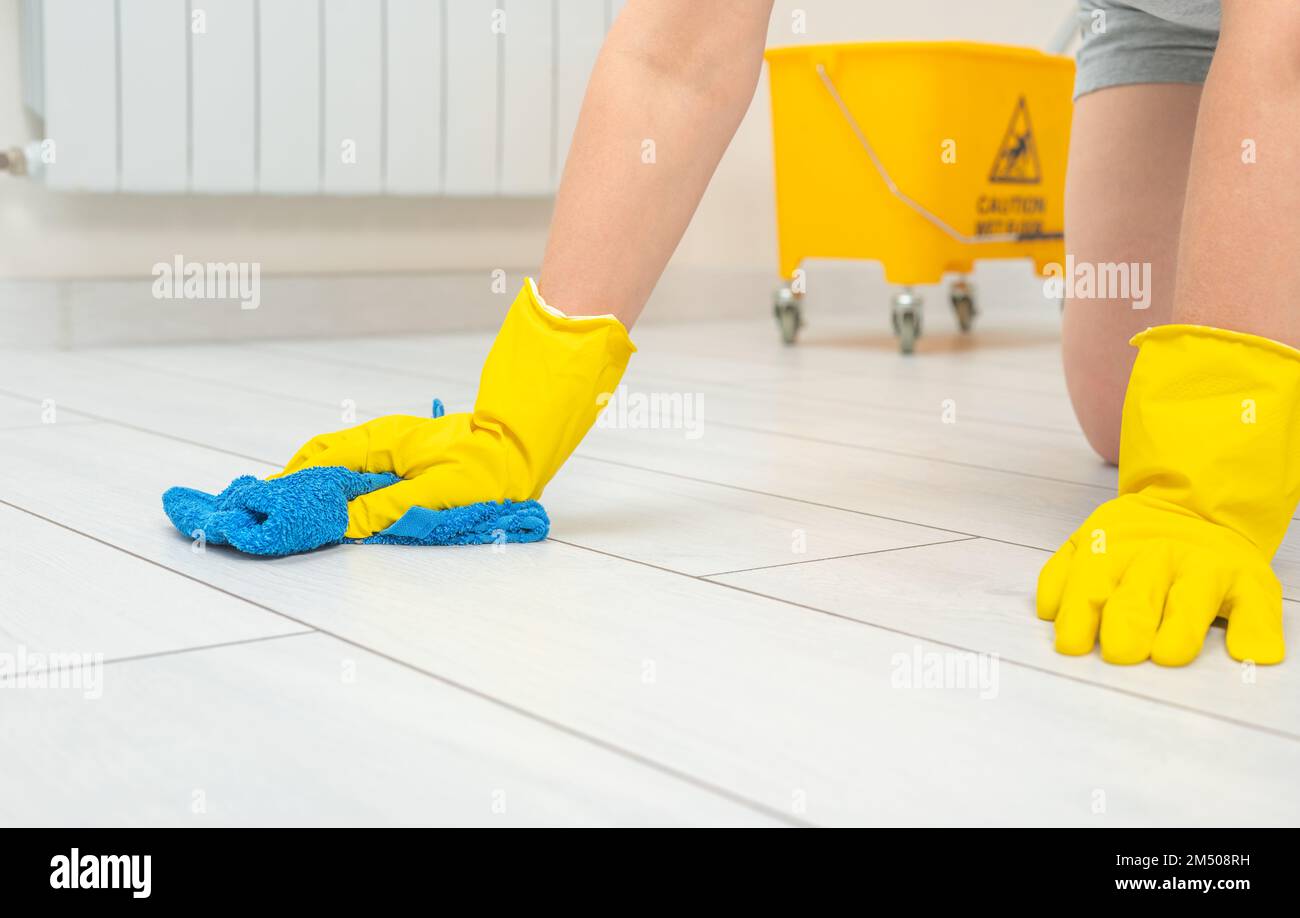 female gloves hands wipe white floor. Professional cleaner washing ...