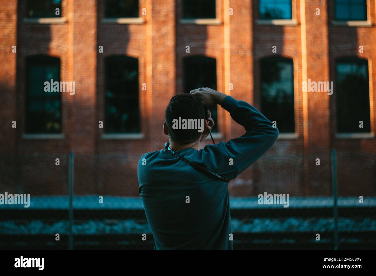 A man from behind taking a picture of architecture Stock Photo - Alamy