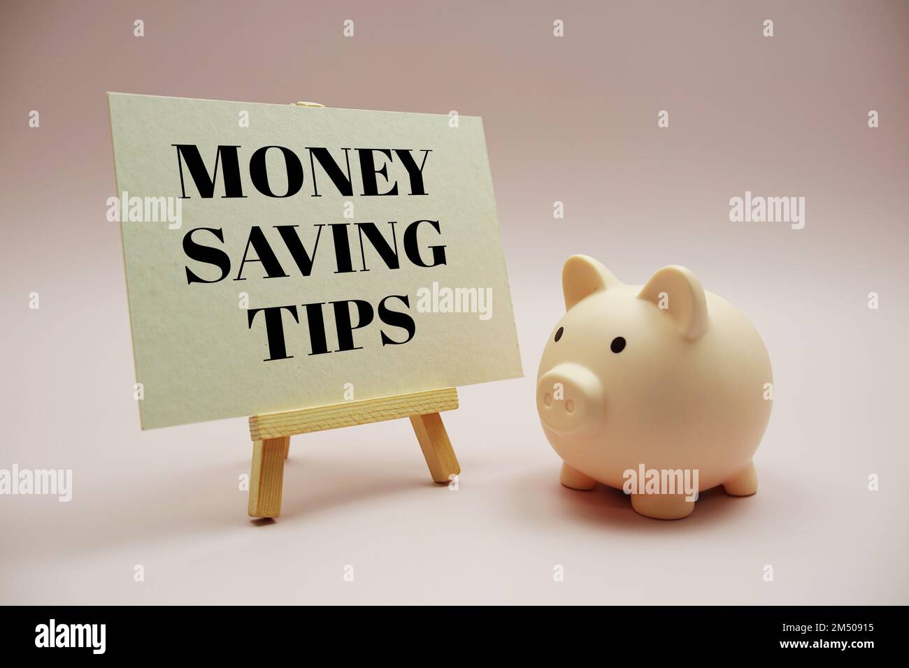 Money Saving Tips text messege and piggy bank on pink background Stock ...