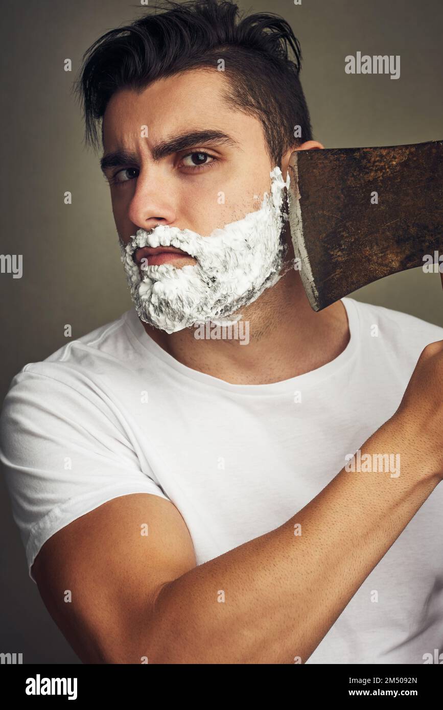 Do it in the most manly way possible. a handsome young man shaving his ...