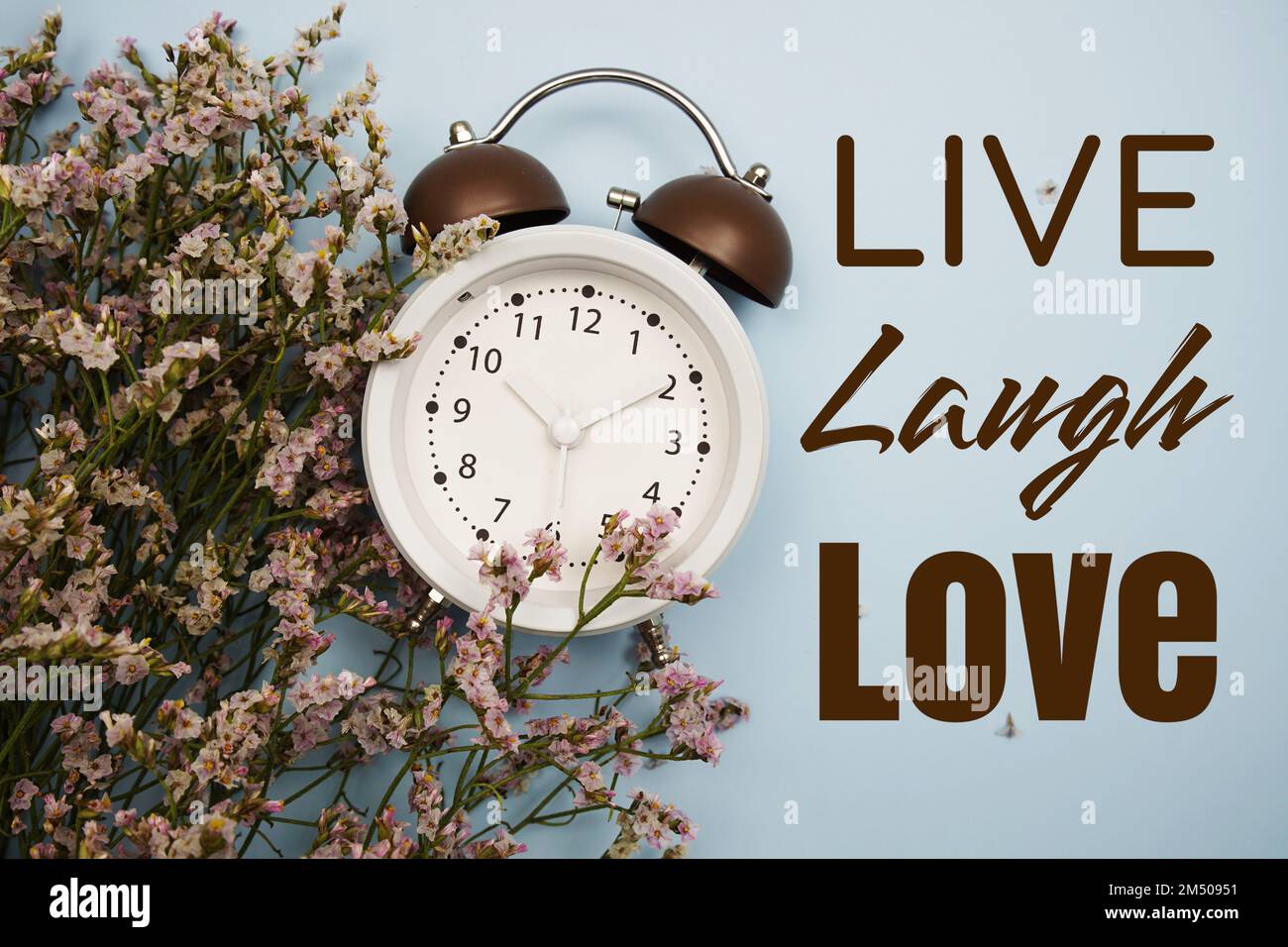 Live Laugh Love text message with alarm clock and flower decoration ...