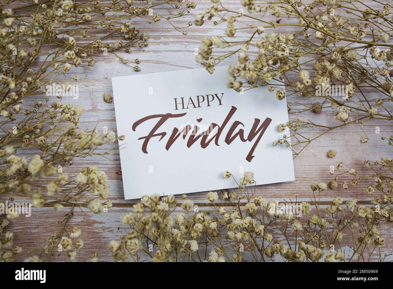 Happy Friday text on paper card with flower decoration on wooden ...