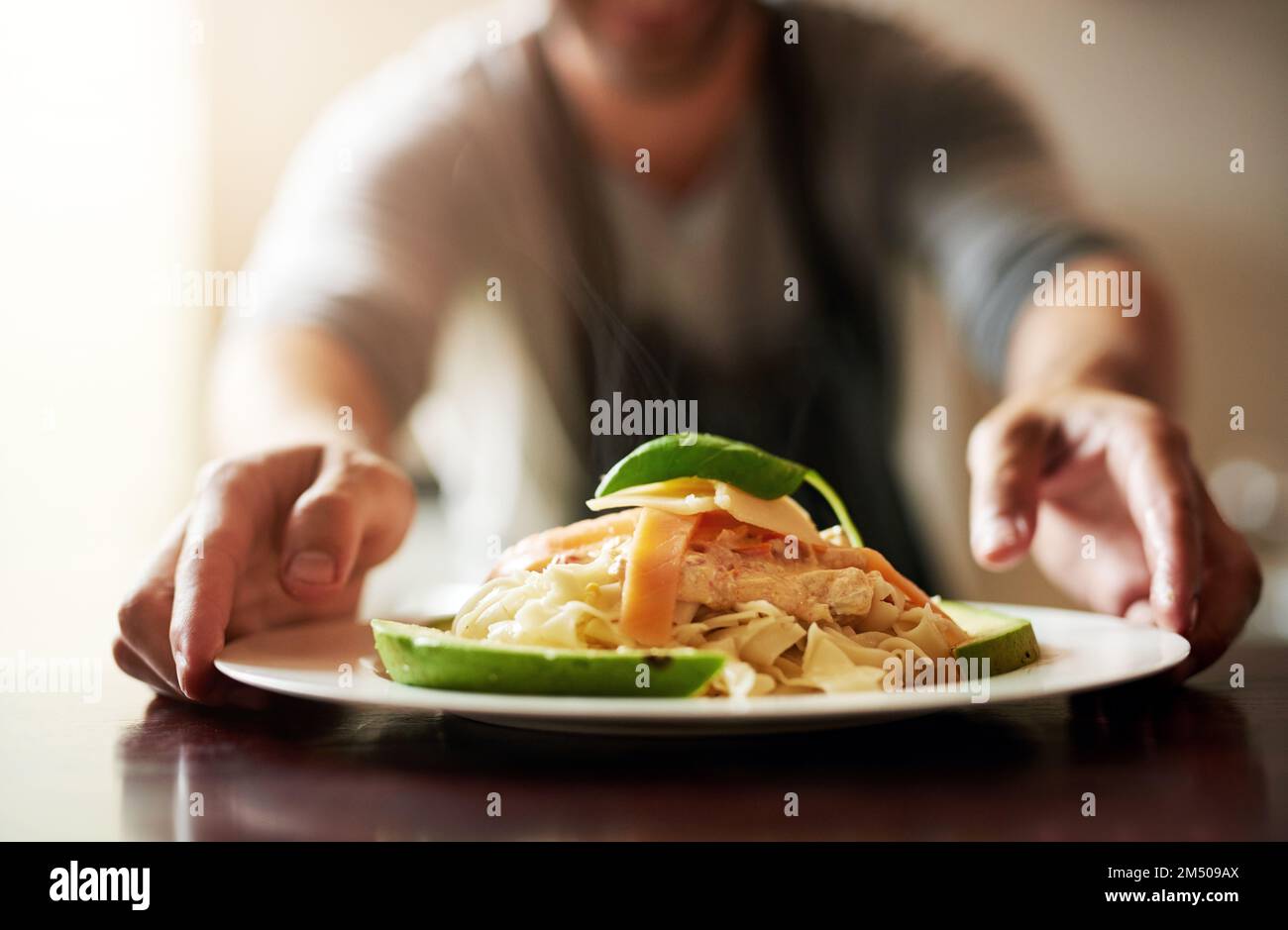 The kitchen is his happy place. an unrecognizable young man serving ...