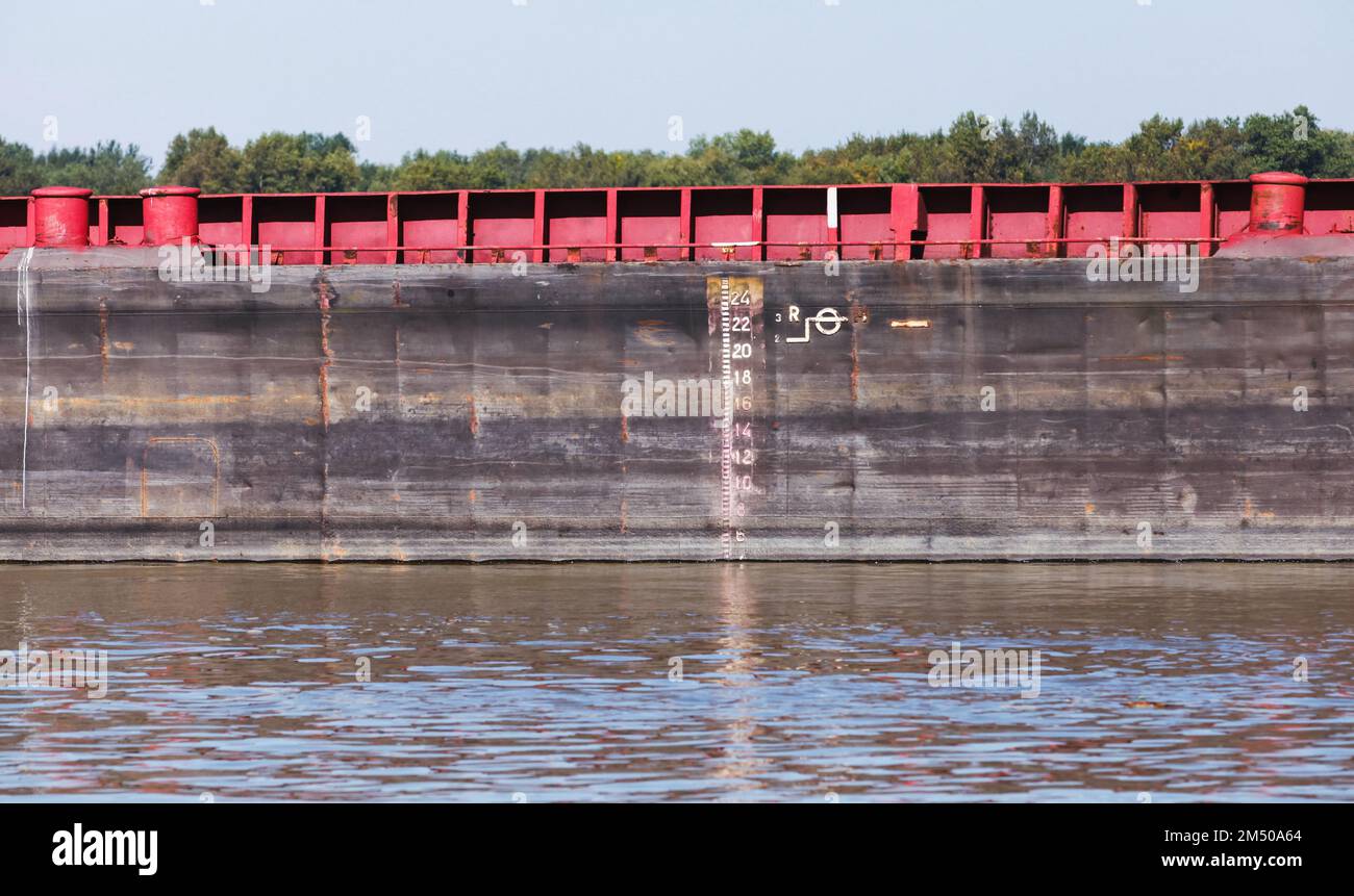 Hull of a bulk carrier ship with draft scale, industrial transportation ...