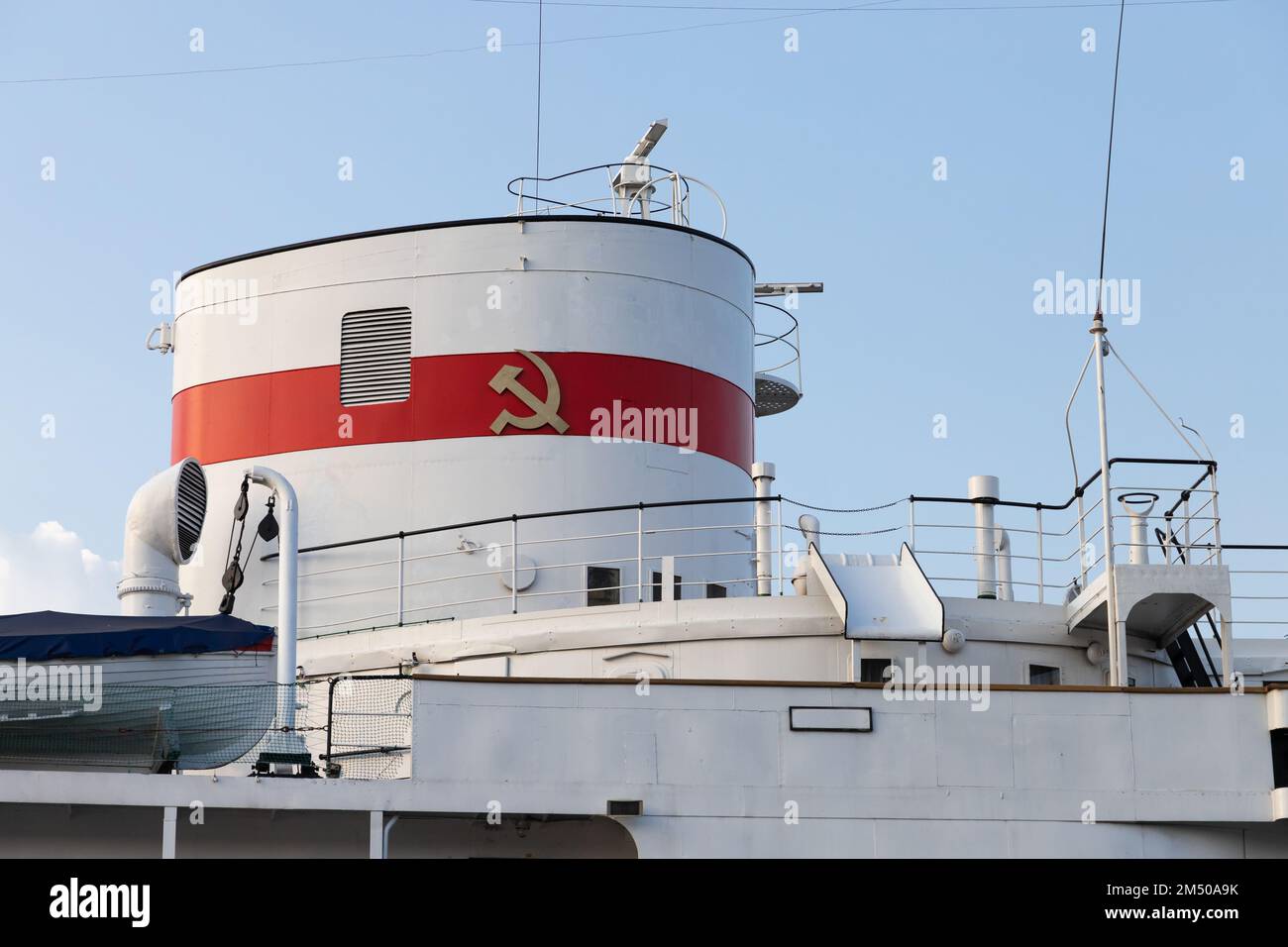 Chimney of a vintage white ship with red stripe and the hammer and ...