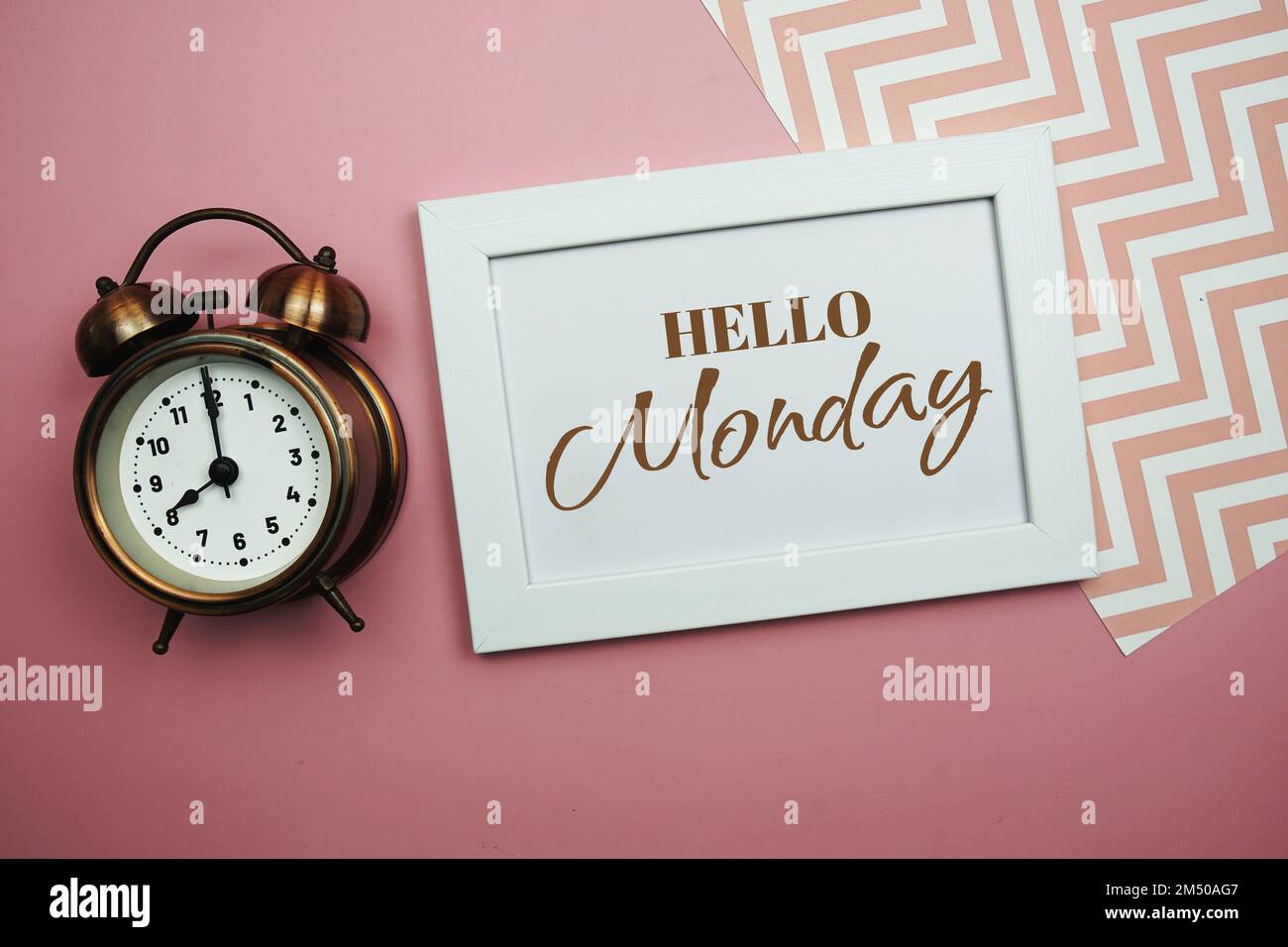 Hello Monday and Alarm clock on pink background Stock Photo - Alamy