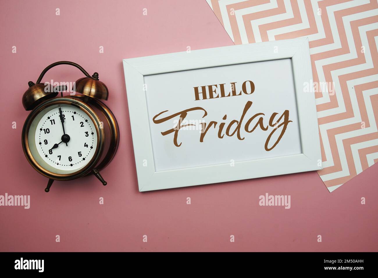 Hello Friday and Alarm clock on pink background Stock Photo - Alamy