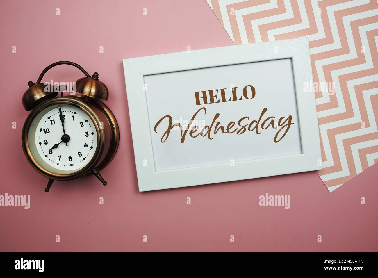 Hello Wednesday and Alarm clock on pink background Stock Photo - Alamy