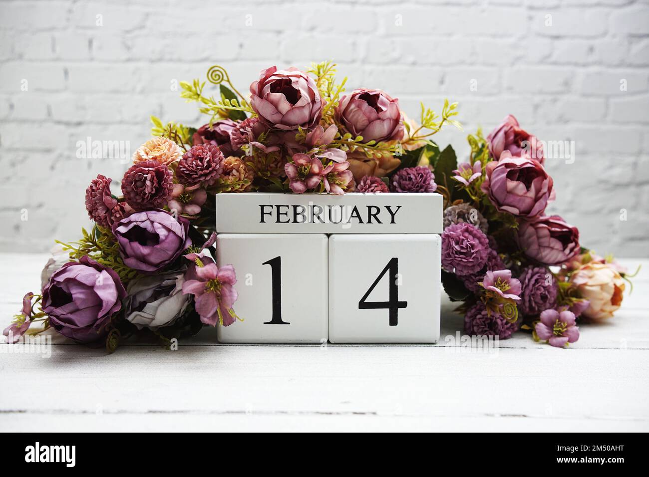 Wooden calendar with date of February 14 on wooden background Stock ...