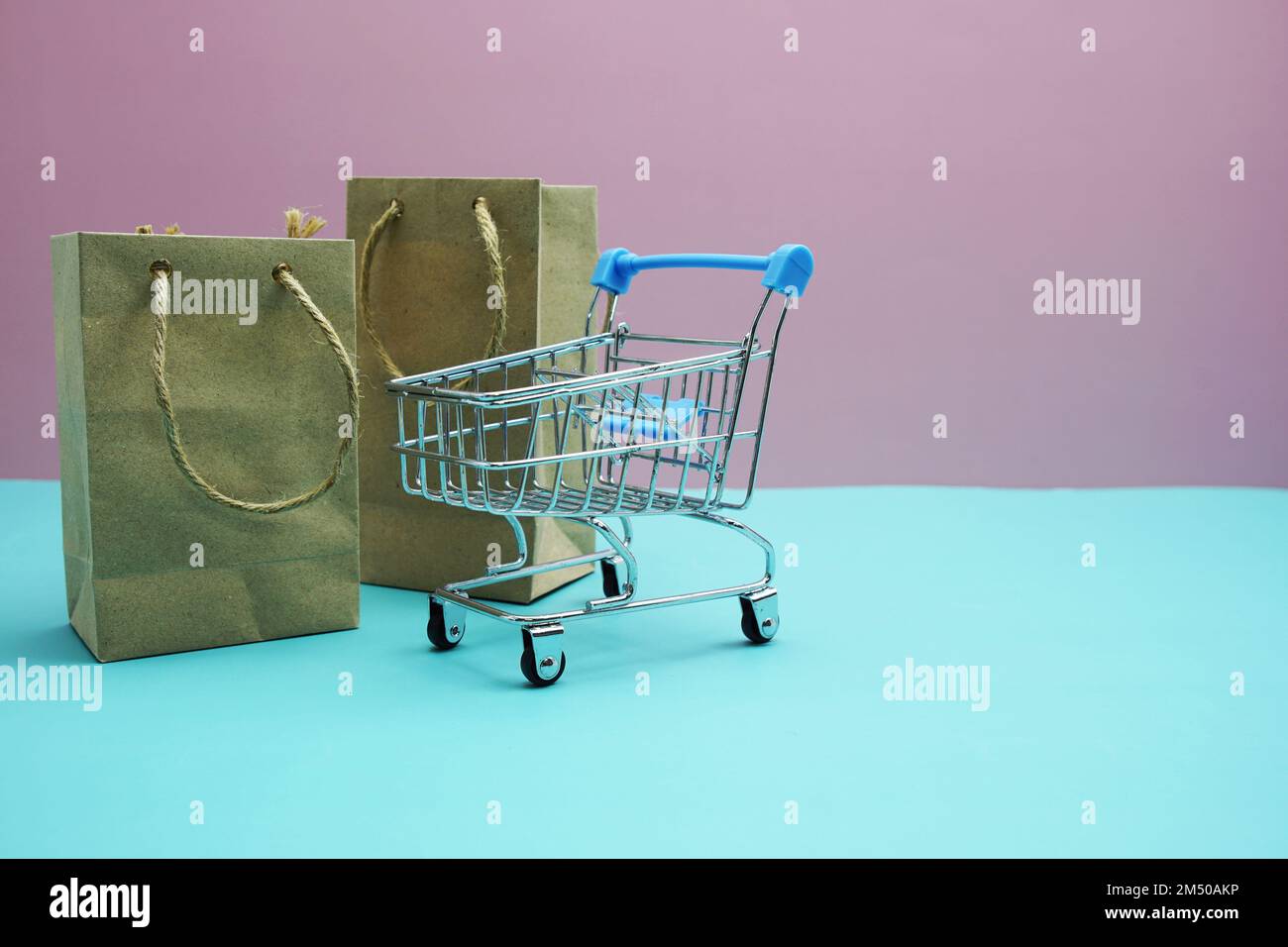 mini Trolley cart and Shopping Bag on pink and blue background Stock ...