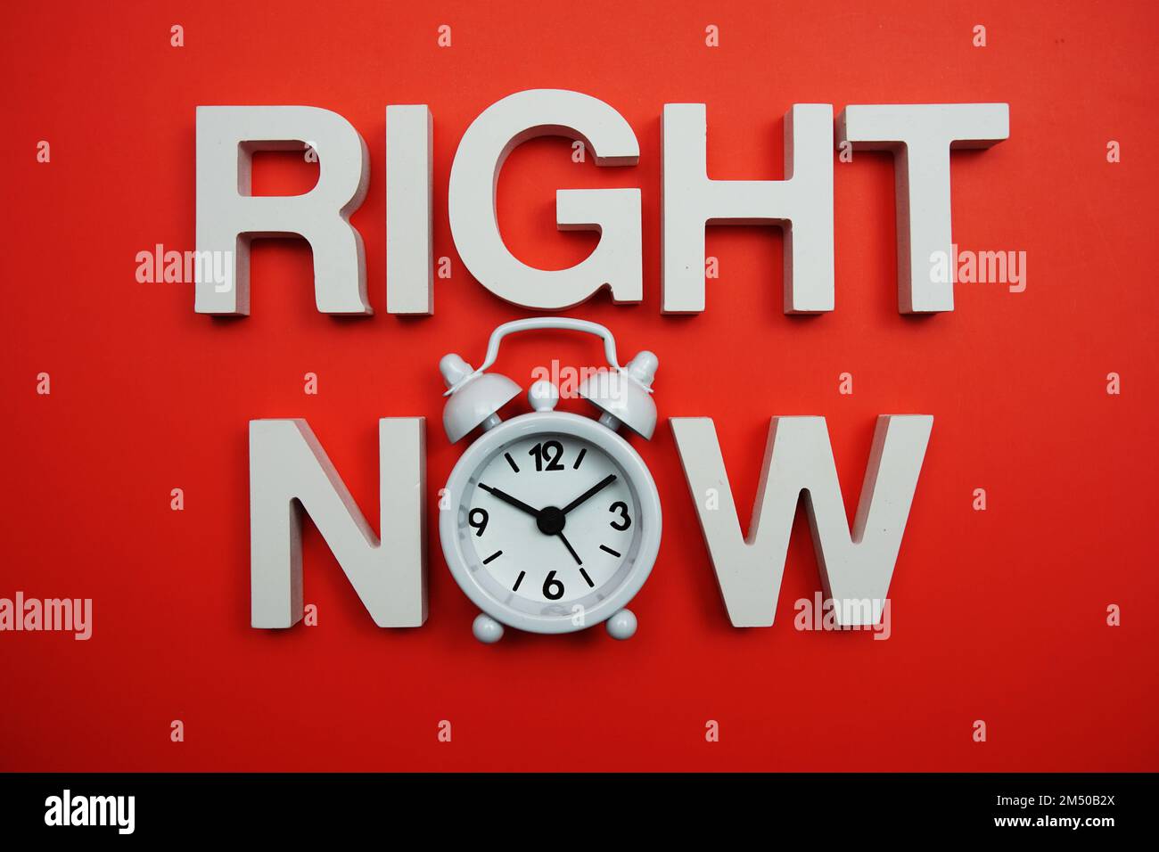 Right Now alphabet letters on red background Stock Photo - Alamy