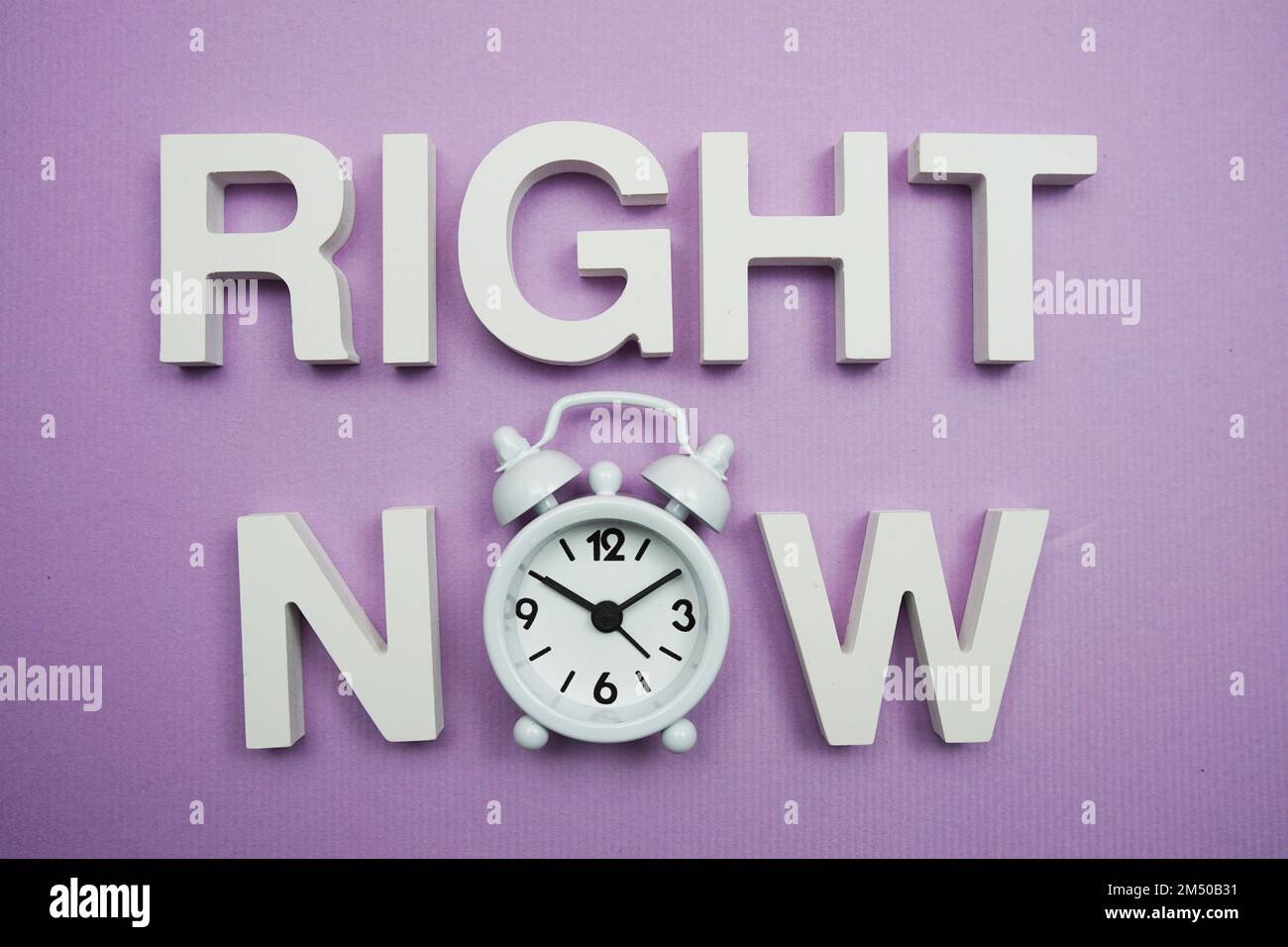 Right Now alphabet letters on purple background Stock Photo - Alamy