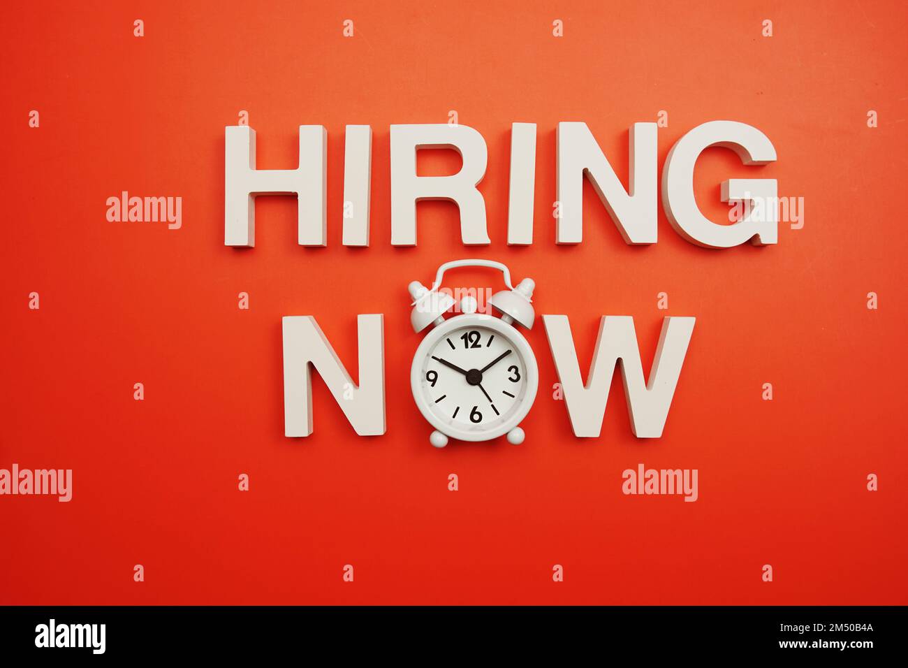 Hiring Now alphabet letters on red background Stock Photo - Alamy