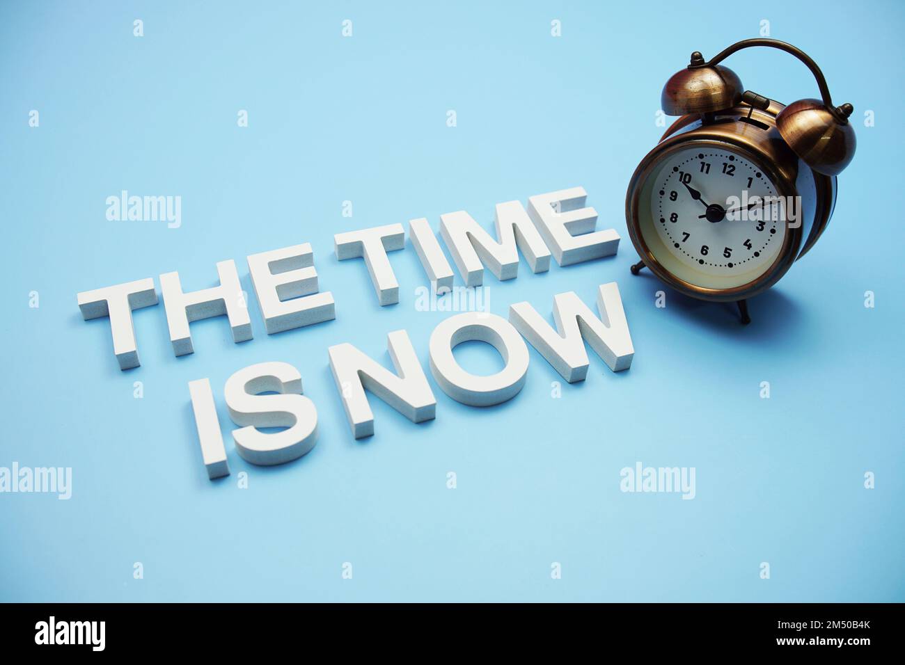 The Time is Now alphabet letters on blue background Stock Photo - Alamy