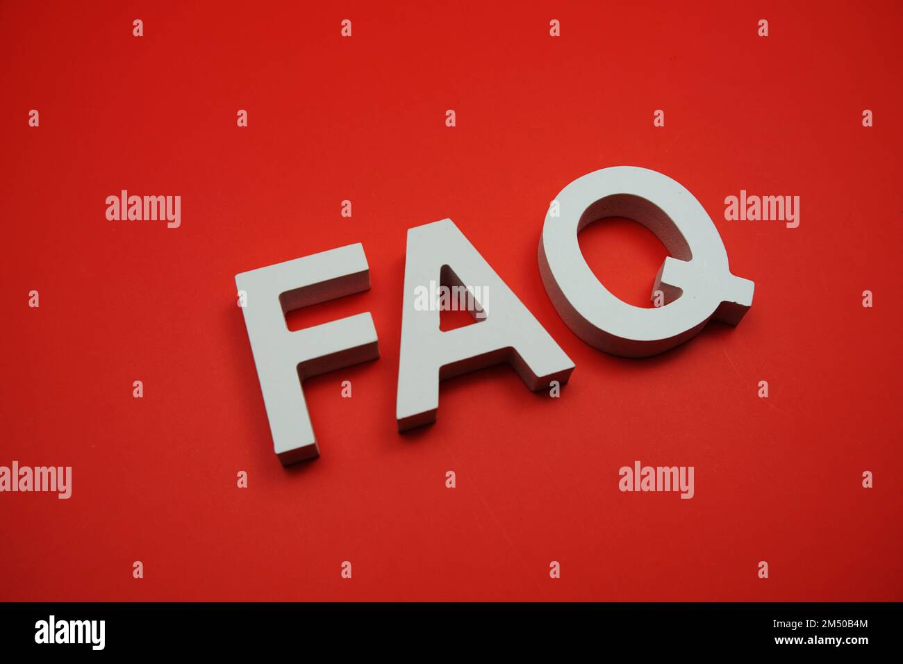 FAQ alphabet letters on red background Stock Photo - Alamy