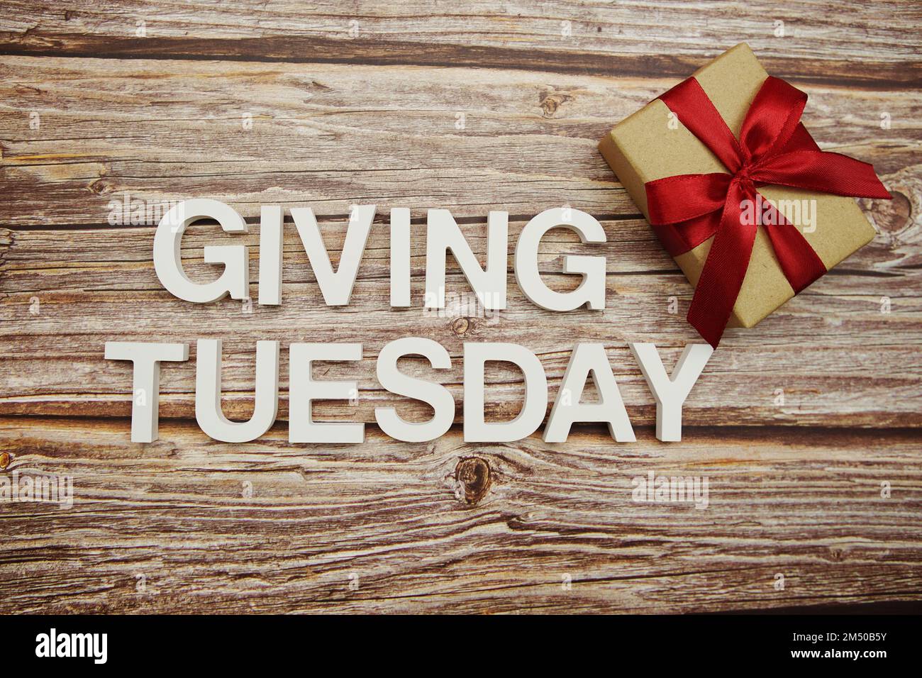 Giving Tuesday alphabet letters and gift box on wooden background Stock ...