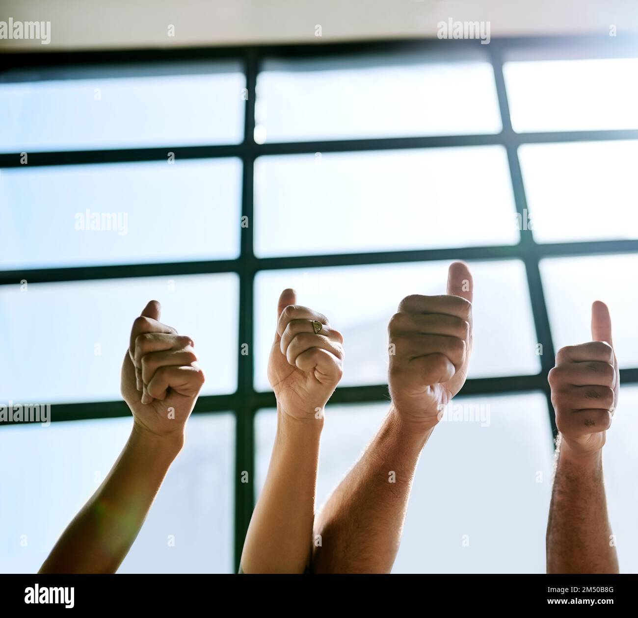 Say yes to teamwork. a group of unrecognizable businesspeople gesturing ...