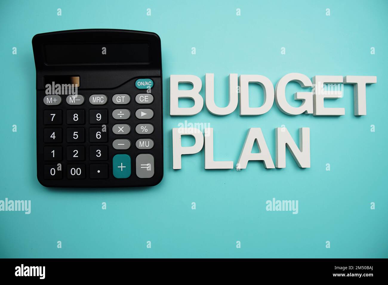 Budget Plan alphabet letters with calculator on blue background Stock ...